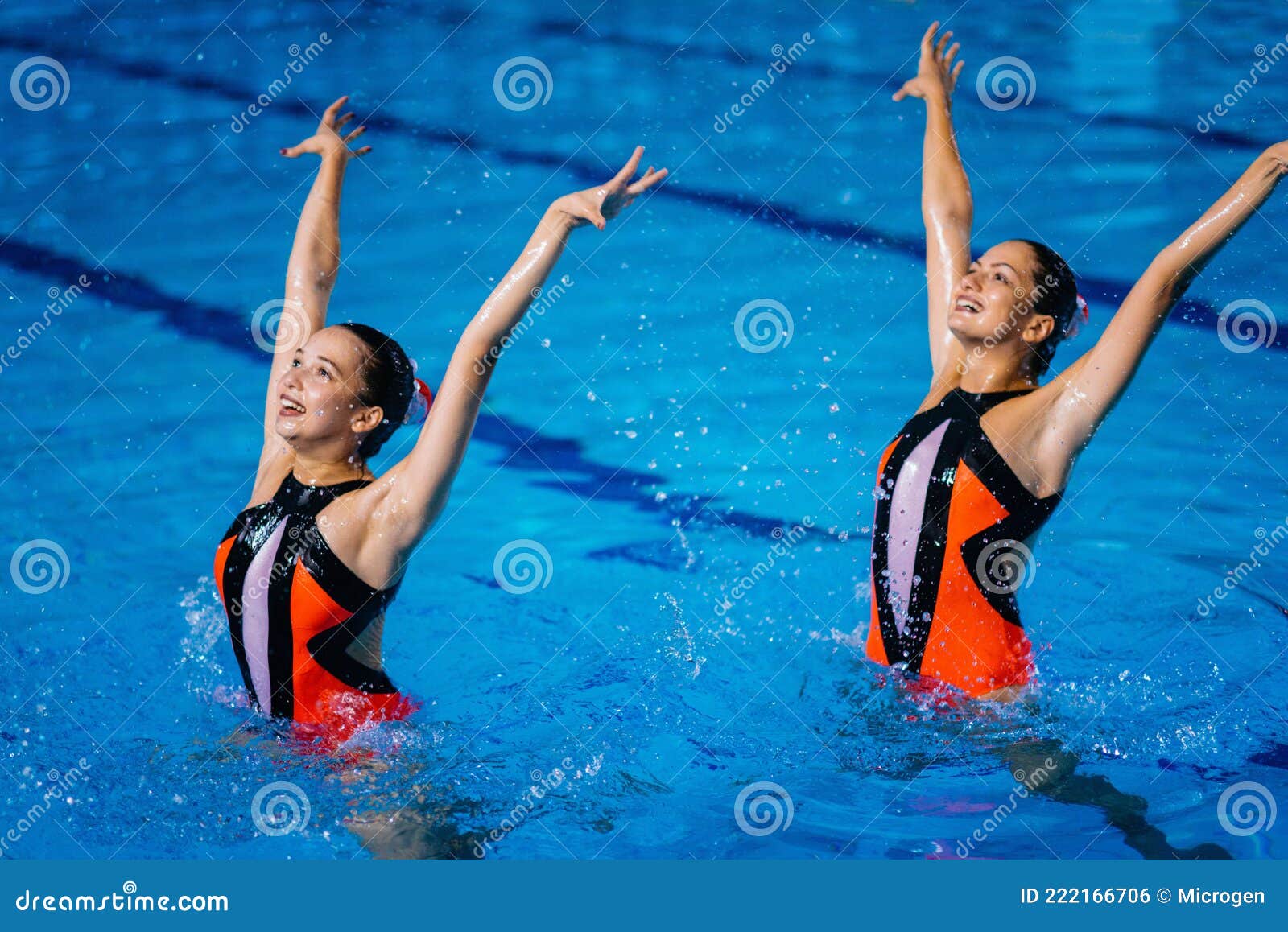 Synchronized Swimmers Performance Stock Photo - Image of indoors, pool ...