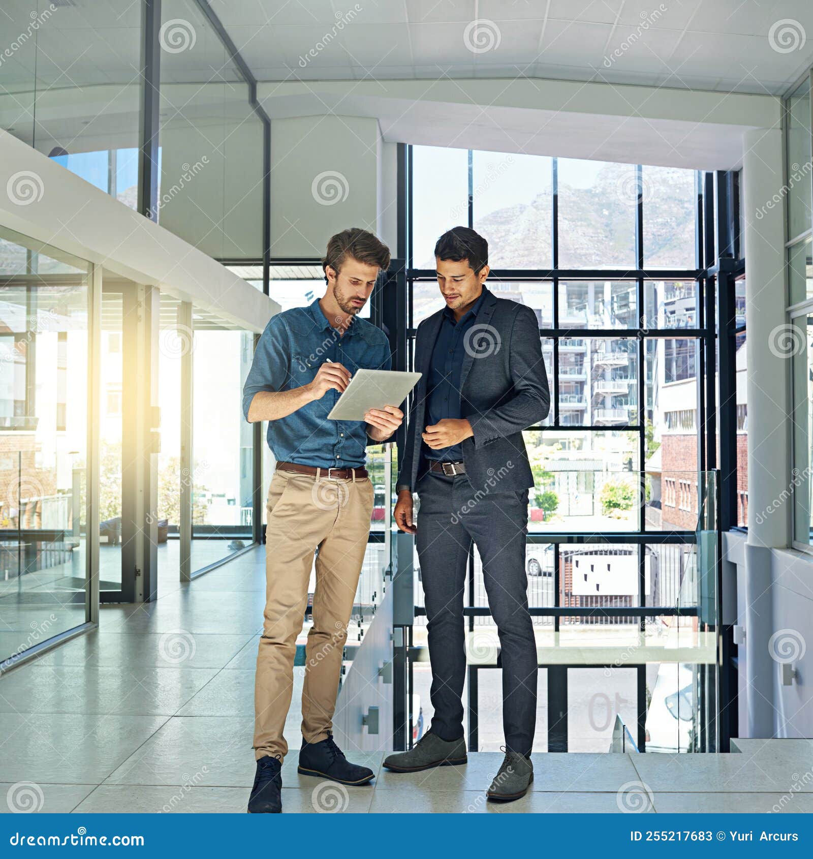 Syncing Their Facts and Figures. Two Colleagues Talking Together Over a ...