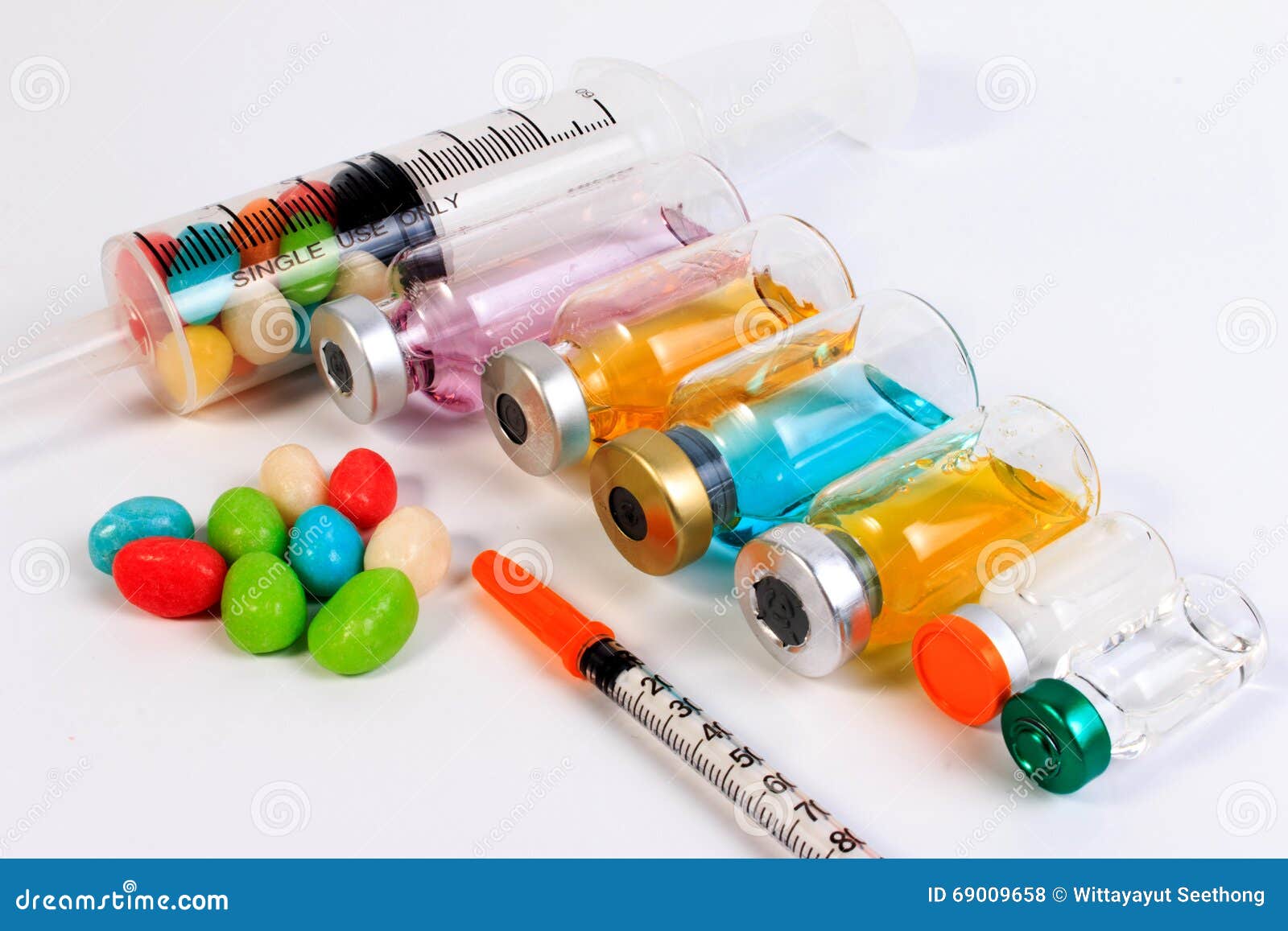 A Syringe and Candy Bottle Isolate on White Background. Stock Photo ...
