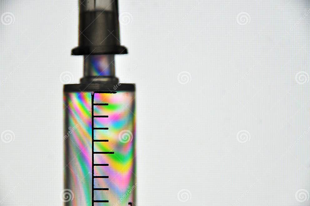 A Syringe with Colorful Rainbow Liquid Inside, an Injection with a ...