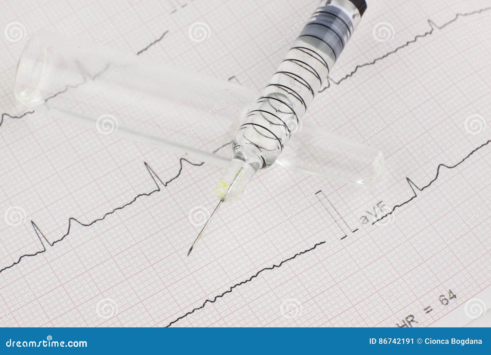 Syringe on EKG heart sheet stock image. Image of colors - 86742191