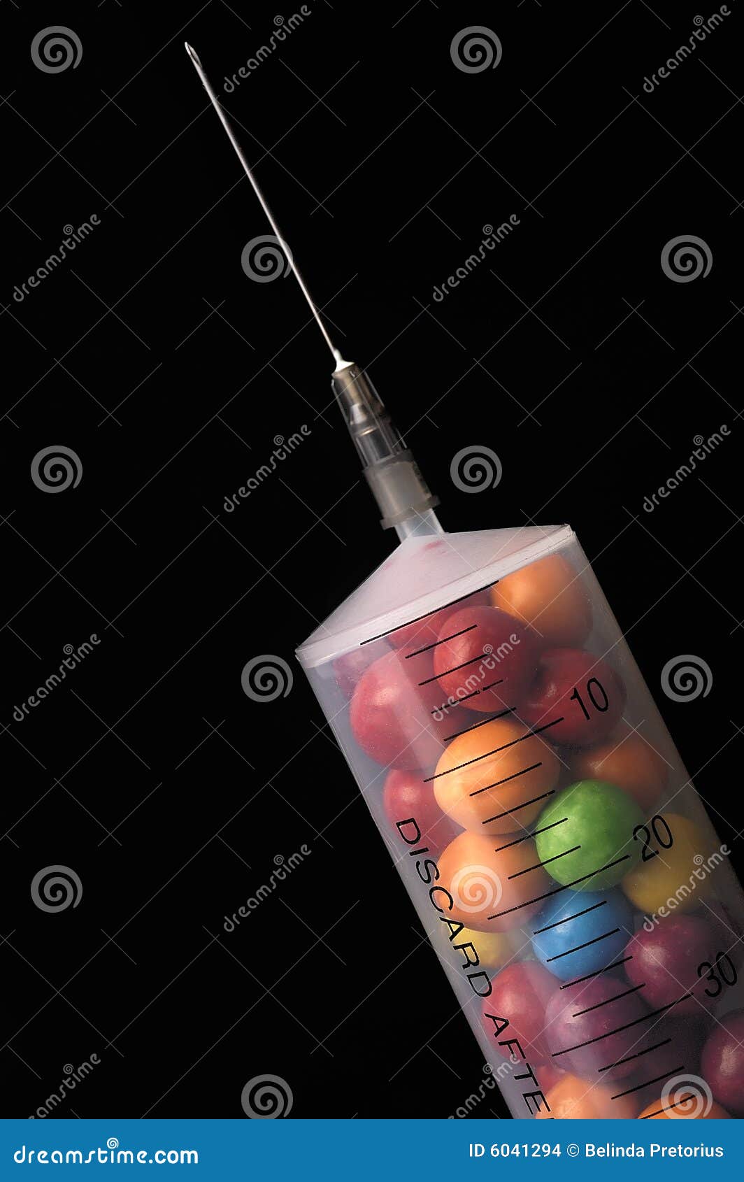 A Syringe Filled with Candy on Black Back Stock Photo - Image of ...