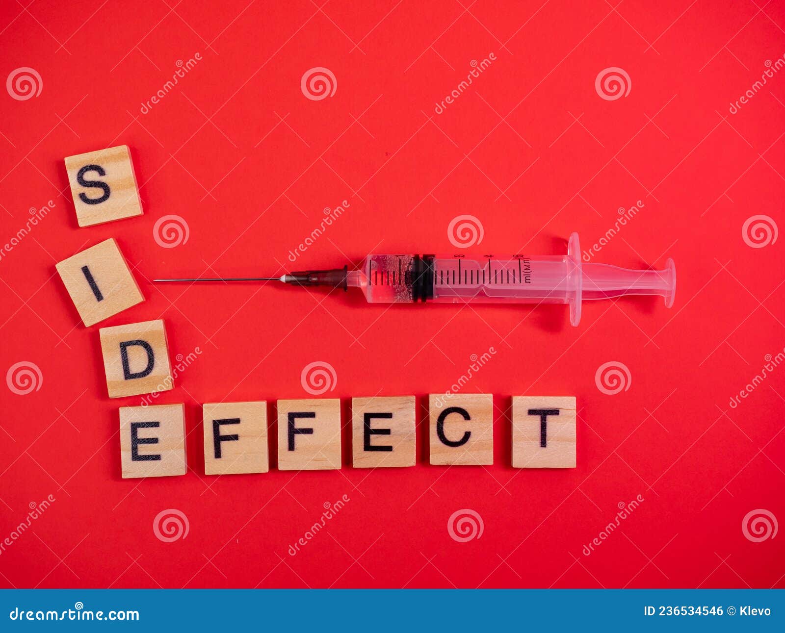 Syringe Filled with Solution. Words Side Effect on Colored Red Paper ...