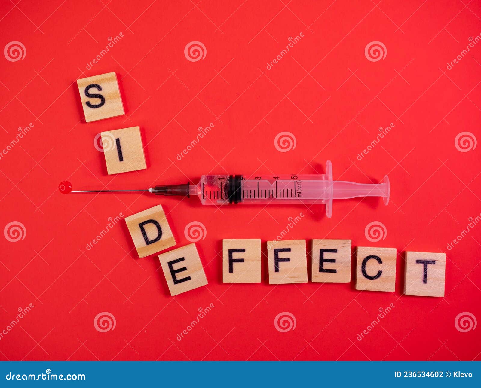 Syringe Filled with Solution. Words Side Effect on Colored Red Paper ...