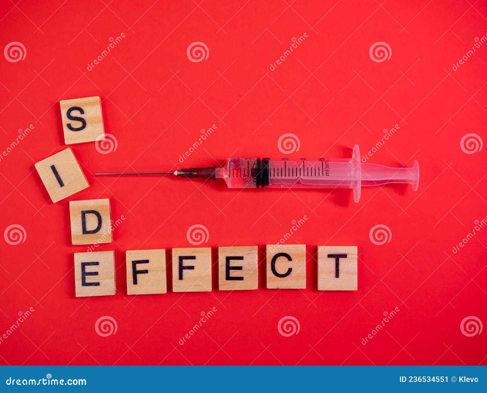 Syringe Filled with Solution. Words Side Effect on Colored Red Paper ...
