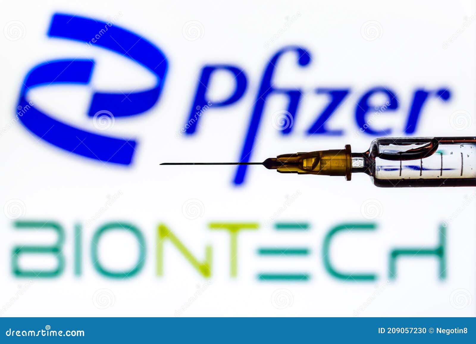 Syringe with Liquid Back Lit by the Logos of Pfizer and Biontech ...