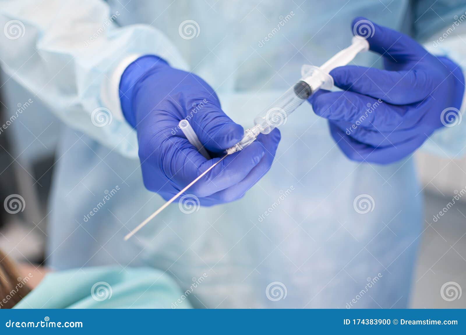 A Syringe with a Long Needle in the Hands of a Dressed Surgeon in the ...