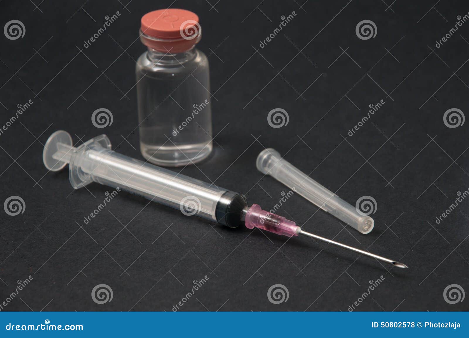 Syringe with a Needle and Cure Bottle on a Black Background Stock Photo ...