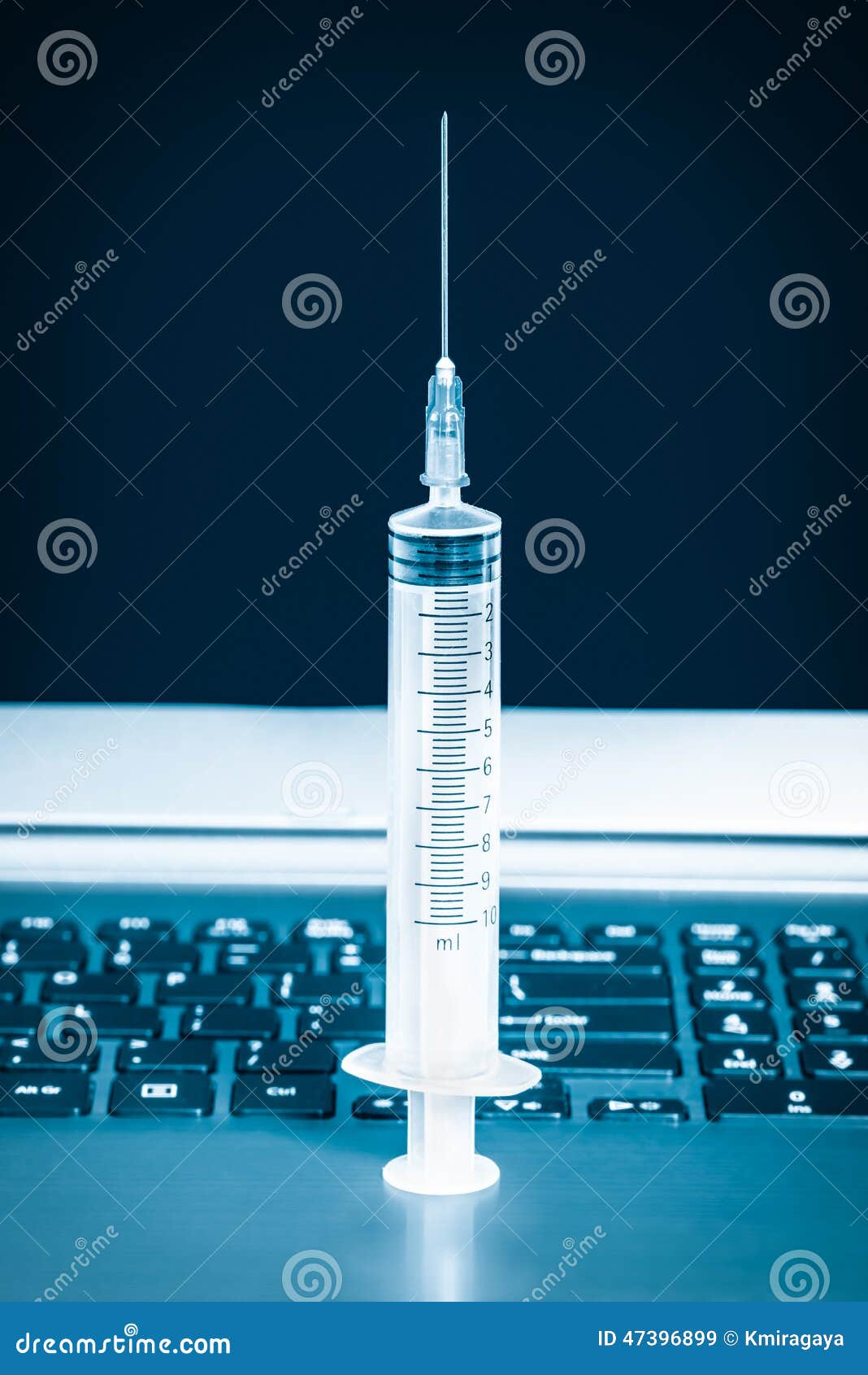 Syringe Next To a Laptop Computer Toned in Blue Stock Image - Image of ...