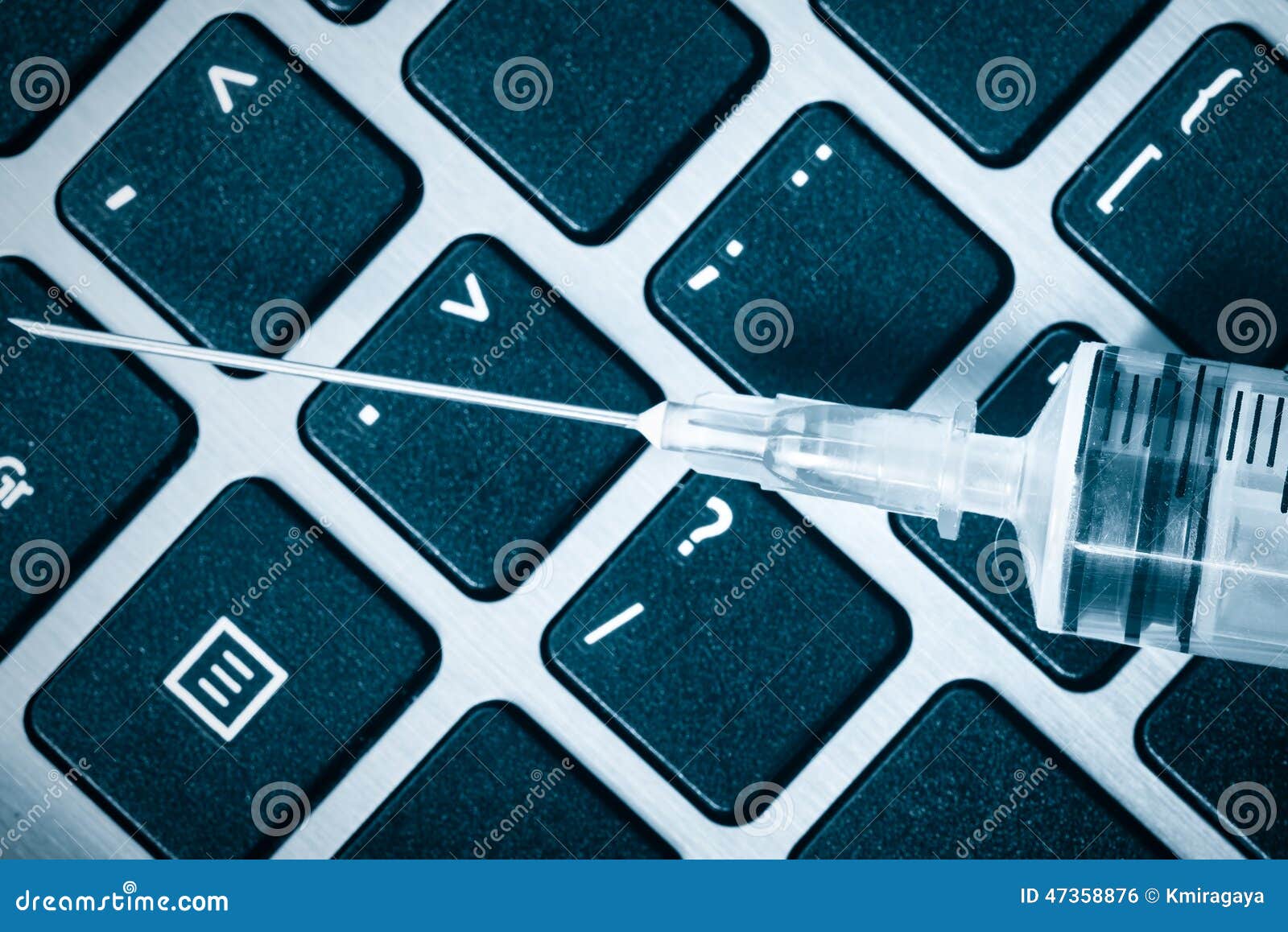 Syringe Over a Computer Keyboard Toned in Blue Stock Photo - Image of ...