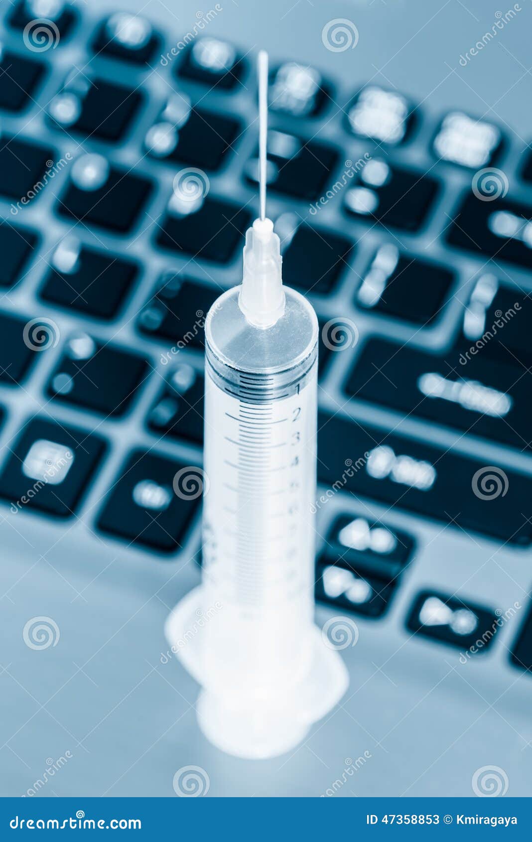 Syringe Over a Computer Keyboard Toned in Blue Stock Image - Image of ...