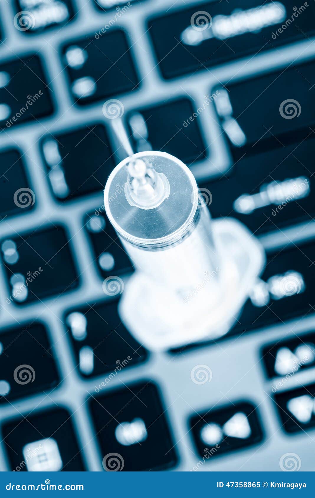 Syringe Over a Computer Keyboard Toned in Blue Stock Image - Image of ...