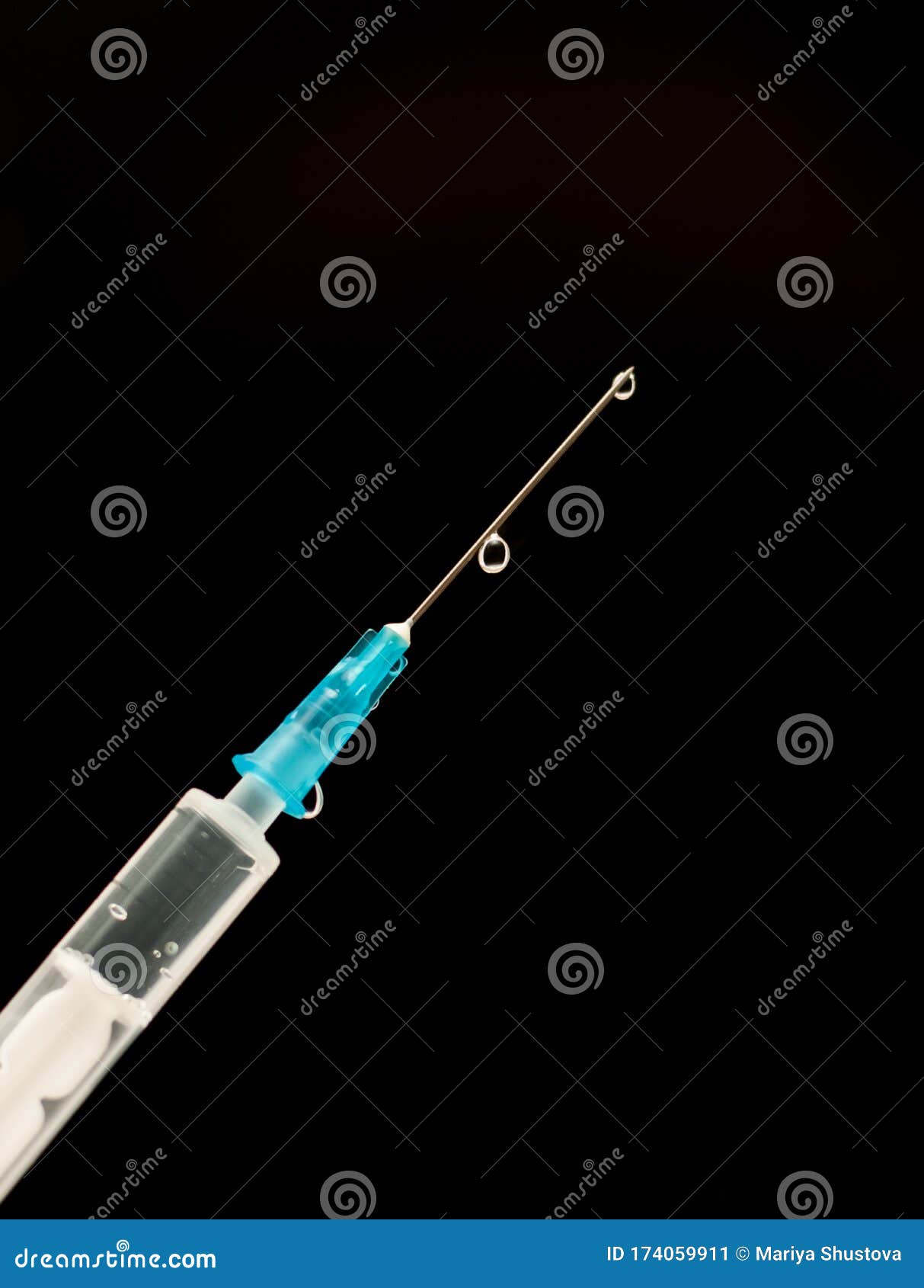 A Syringe with a Vaccine and a Needle. Liquid Drips from the Needle ...