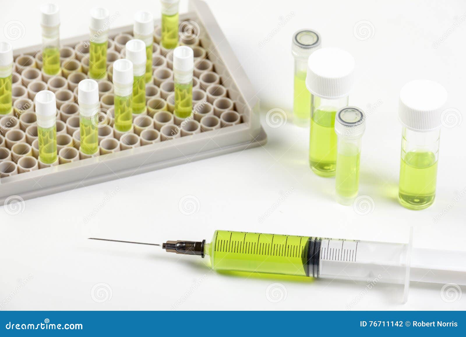 Syringe and Vials Containing Green Fluid on Lab Bench Stock Photo ...