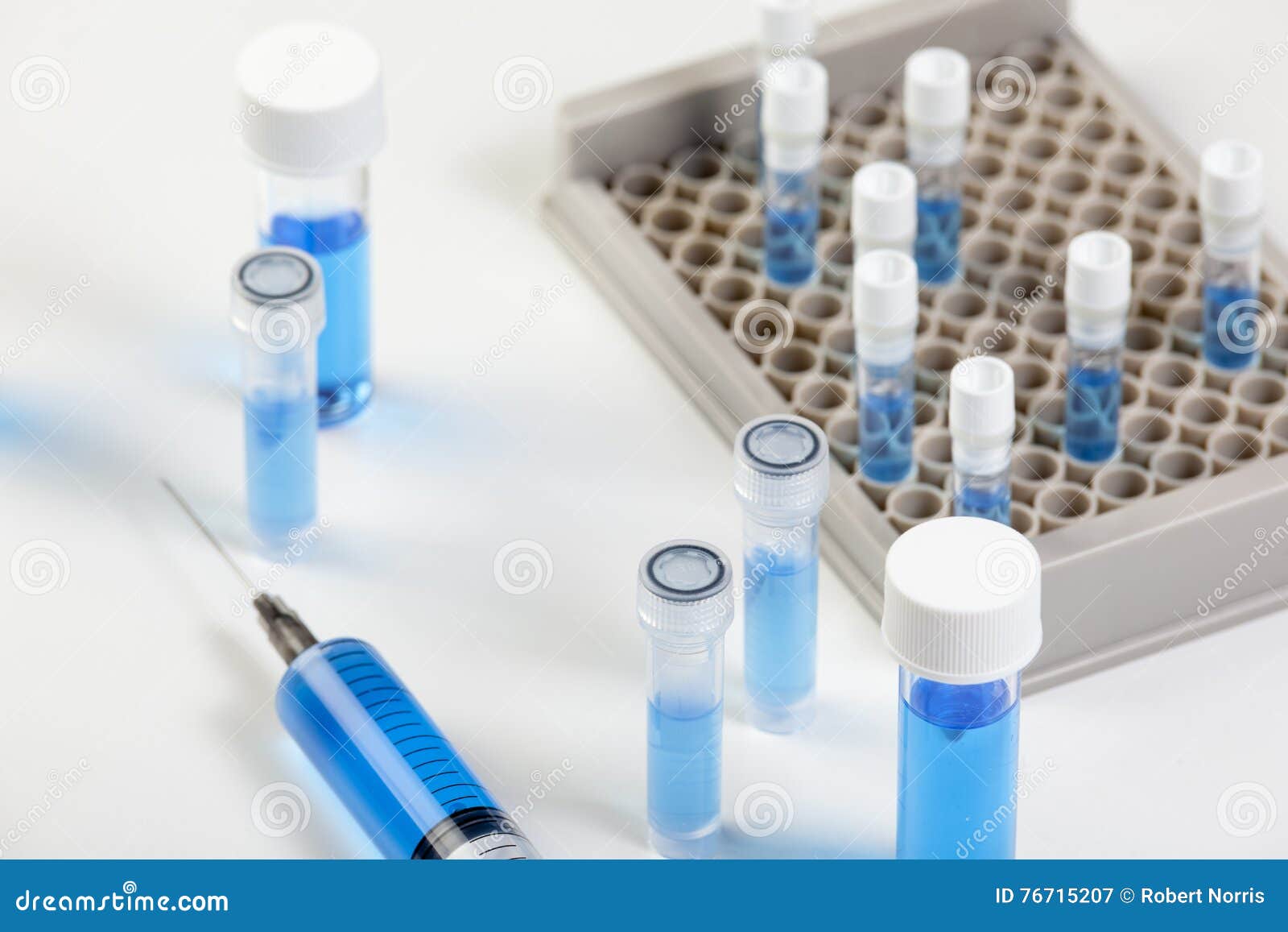 Syringe and Vials Loaded with Blue Fluid on Bench Stock Image - Image ...