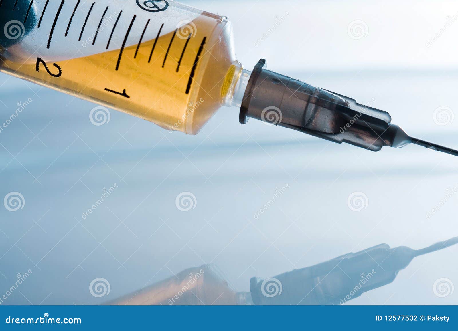 Syringe with yellow liquid stock photo. Image of care - 12577502