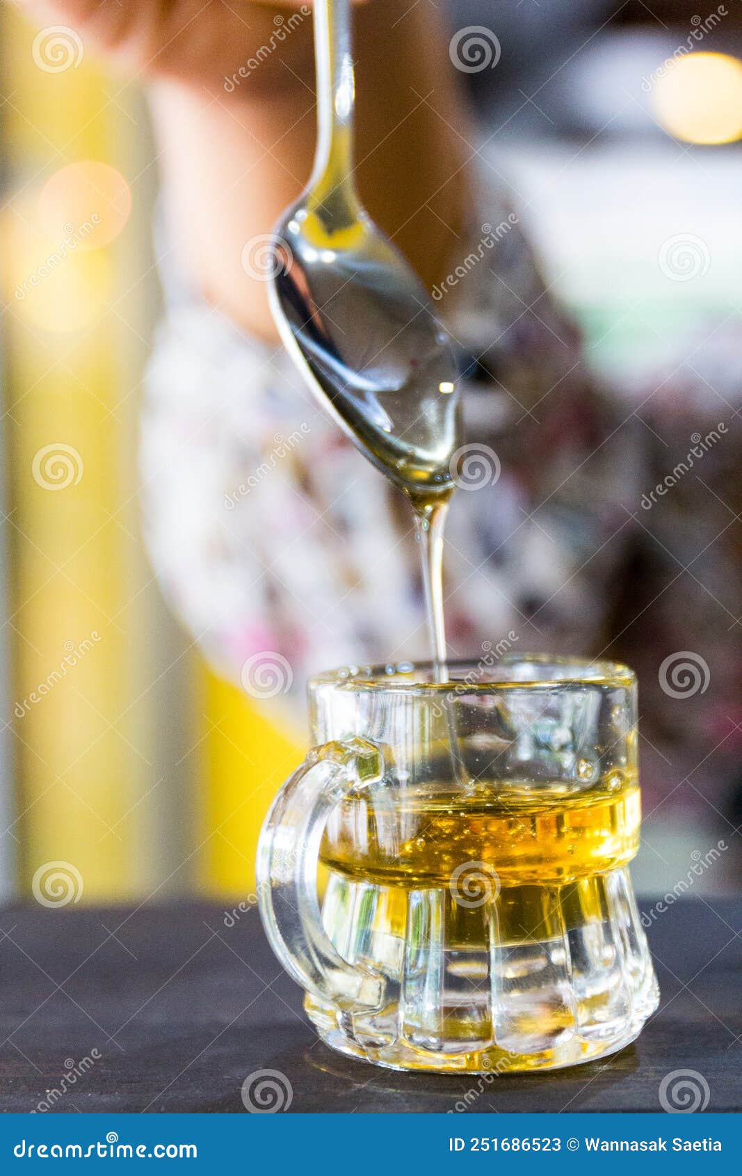 Syrup drips from a spoon stock image. Image of pour - 251686523