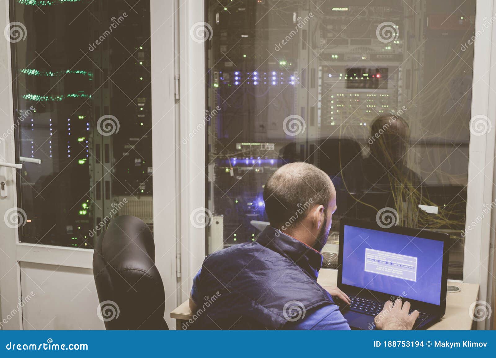 The System Administrator with a Laptop Works in a Modern Data Center ...