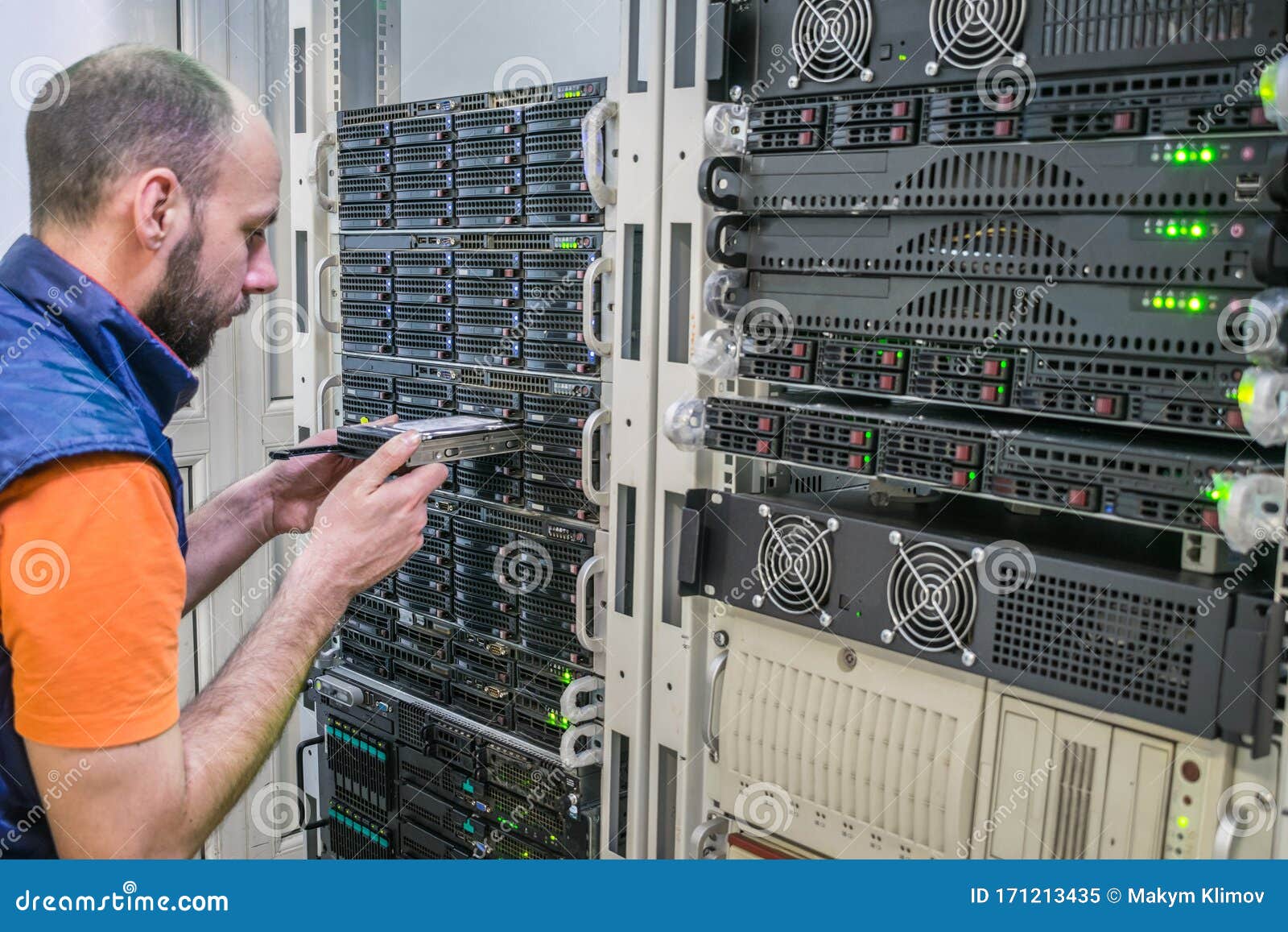 The System Administrator Replaces the Data Disk. a Man Works in the ...