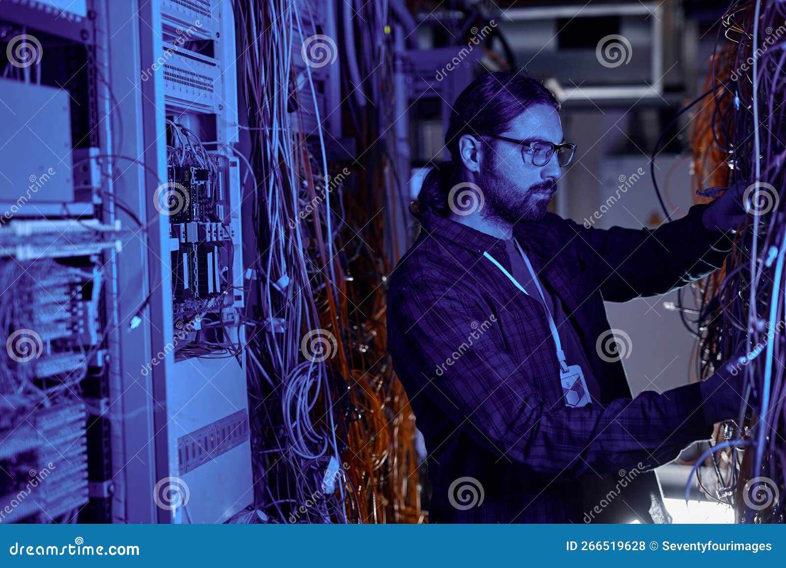 System Administrator Working with Server in Neon Light Stock Photo ...