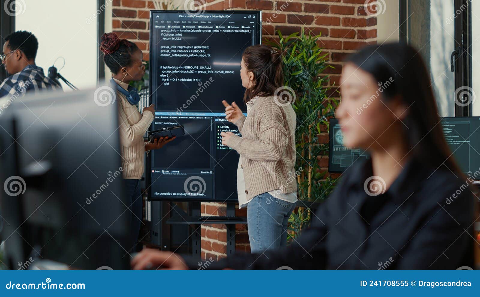 System Engineers Comparing Source Code on Wall Screen Tv Analyzing Errors Using Digital Tablet ...