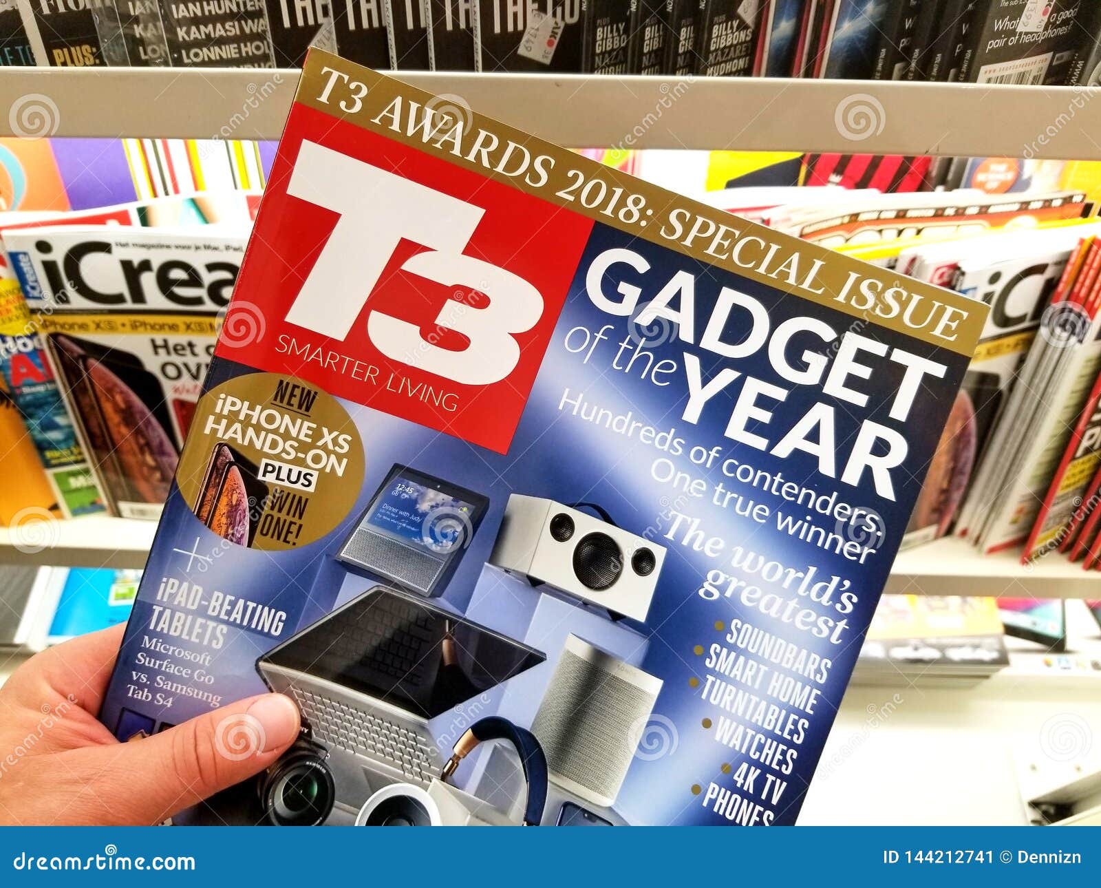 T3 magazine in a hand editorial photo. Image of culture - 144212741