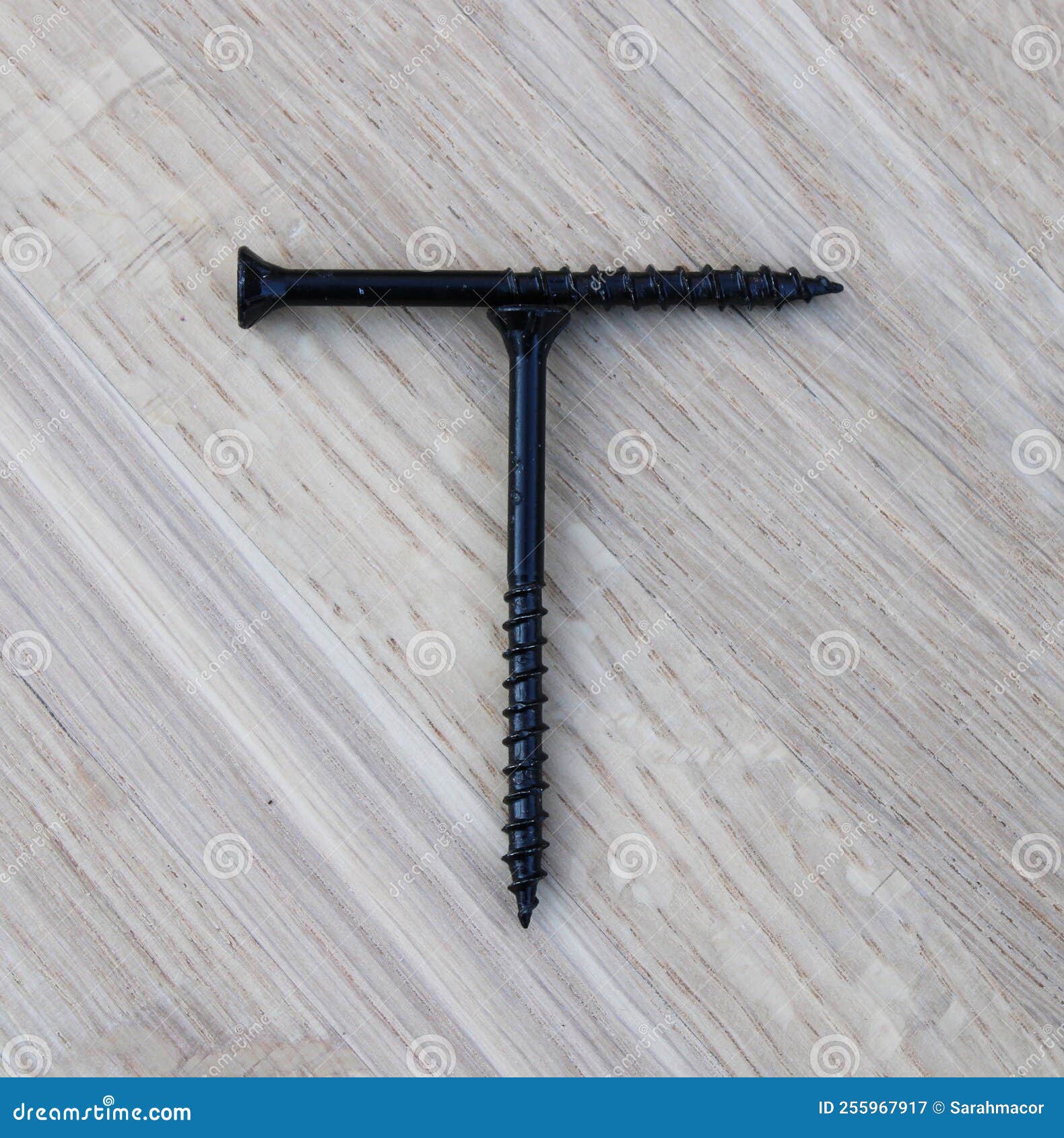 A T Shape Created with Two Black Screws Stock Image - Image of shape ...