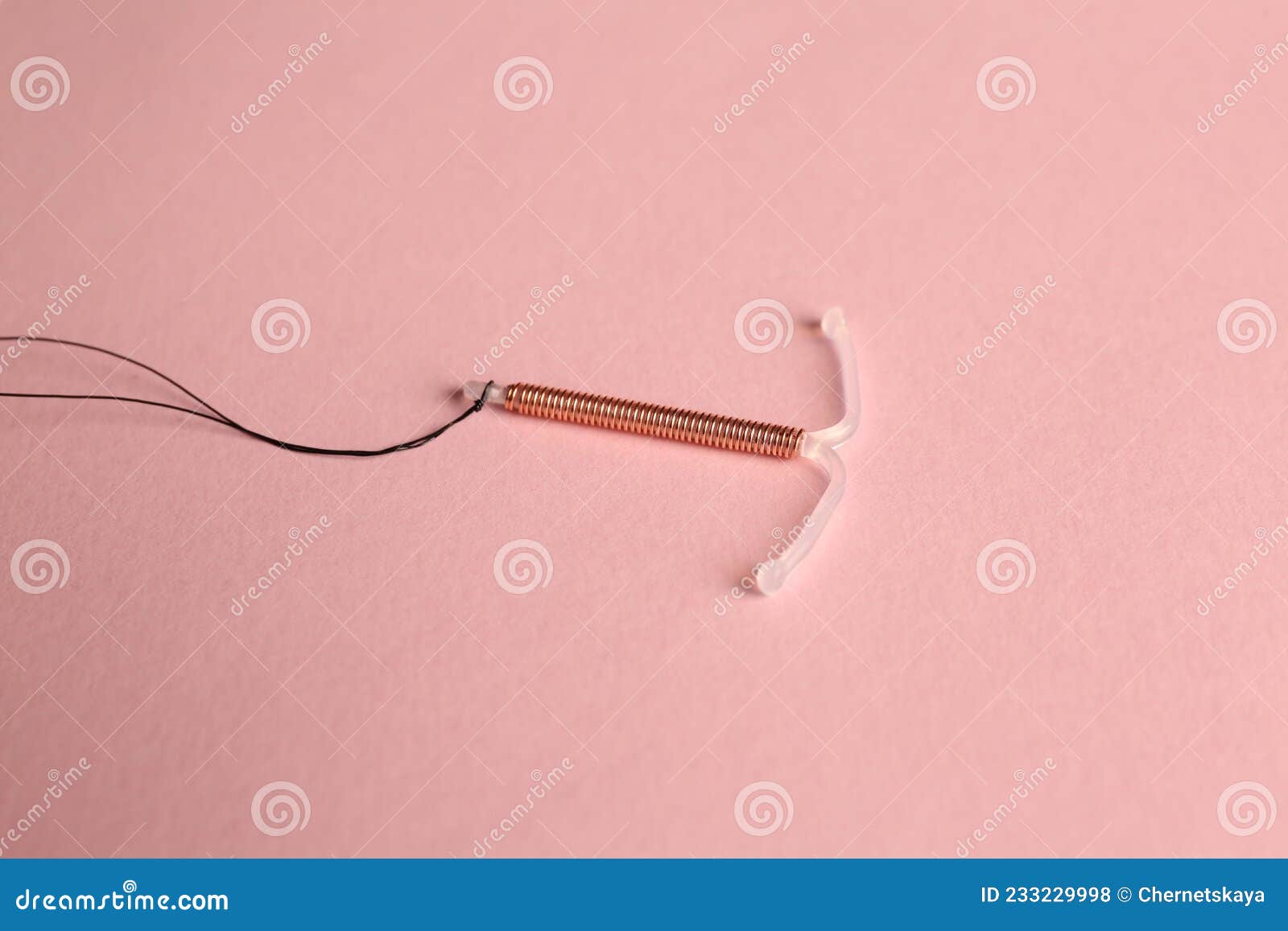 T Shaped Intrauterine Birth Control Device On Pink Background Stock