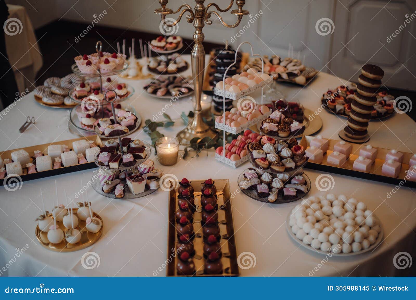 Table with Assorted Desserts and a Lit Candle. Stock Image - Image of ...