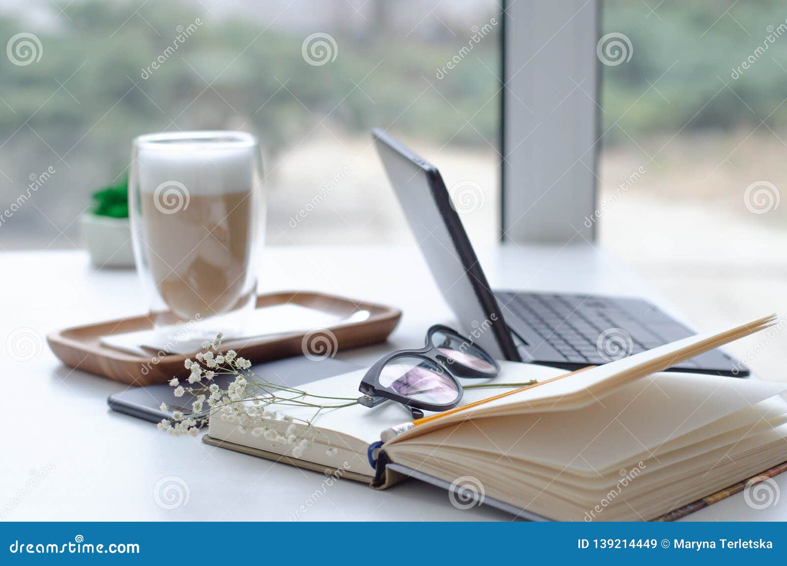 A Table in a Bright Cafe with Latte and Freelancer Work Details. Stock ...