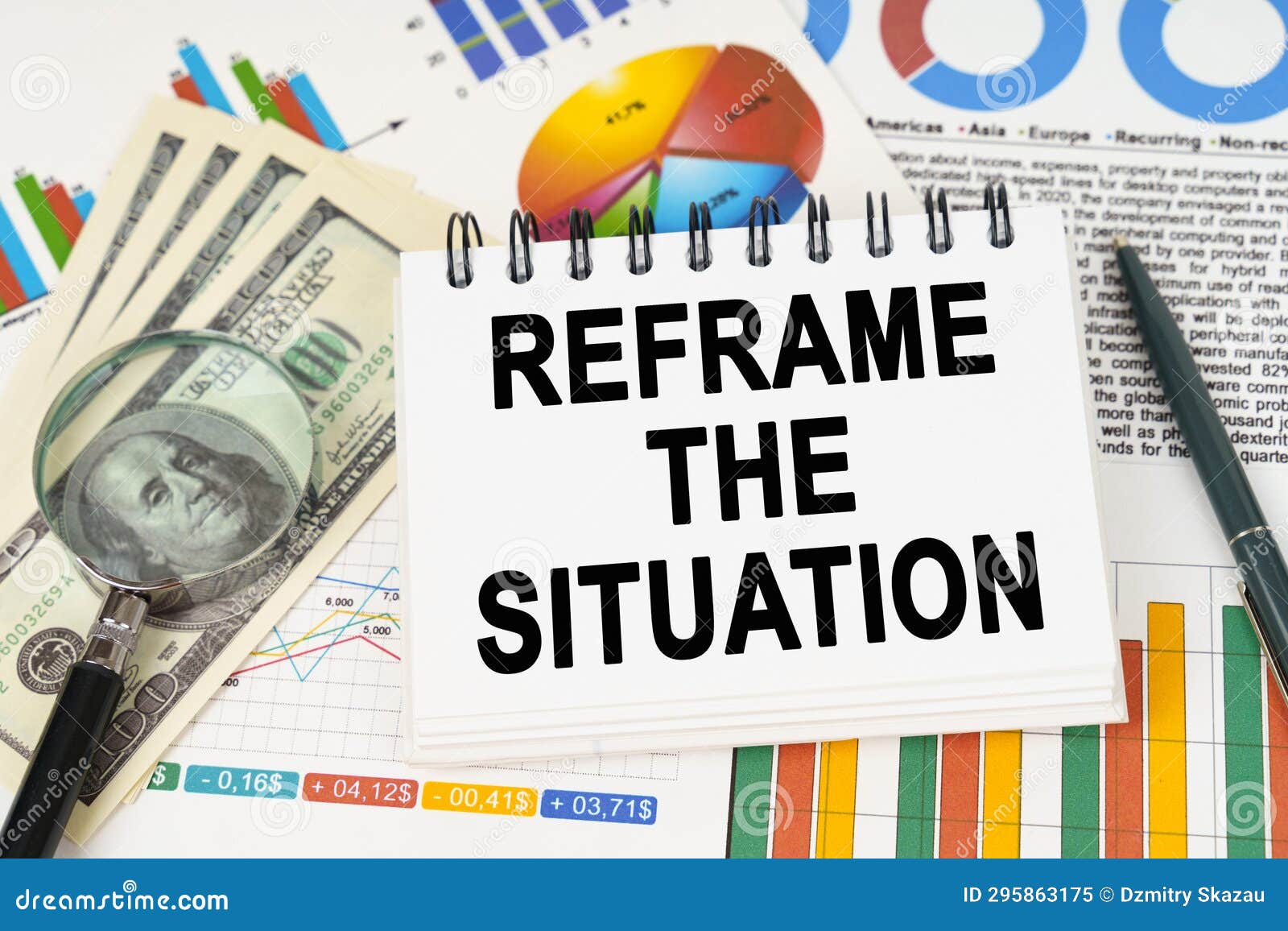 On the Table are Business Charts, Dollars and a Notepad with the ...