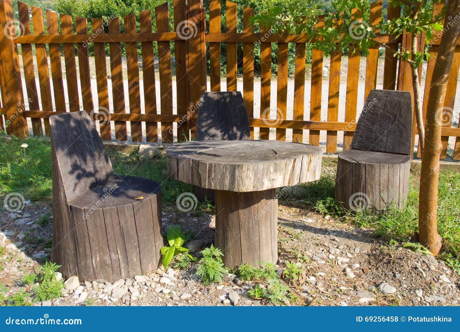 Table and Chair of Tree Trunks Stock Photo - Image of cottage, street ...