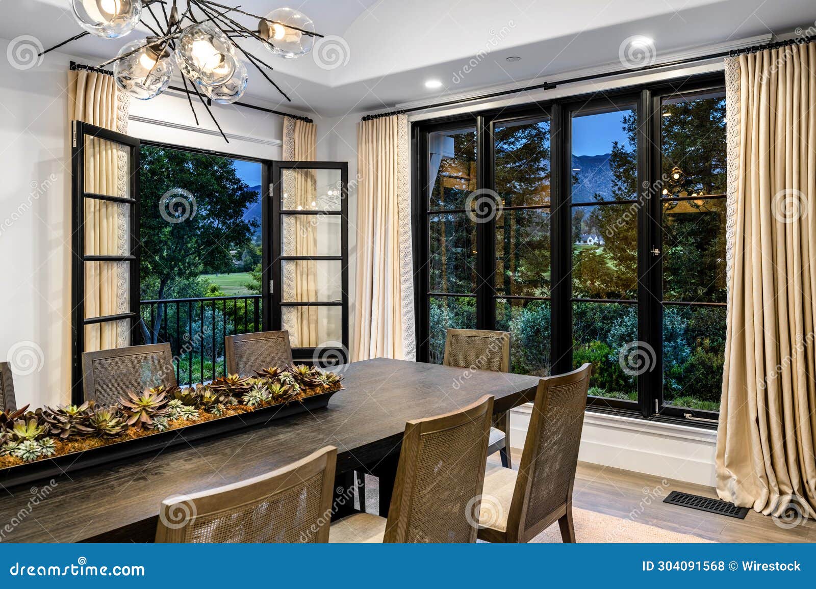 A Table that Has Some Chairs Near a Window with Glass Stock Photo ...
