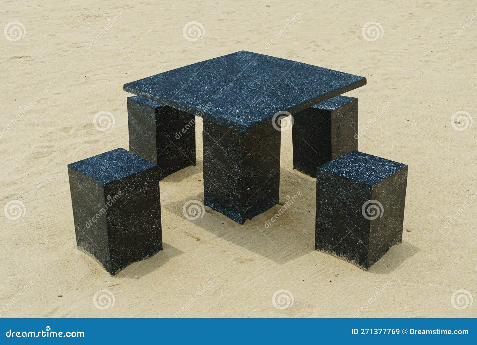 A Table and Chairs Made of Stone Stands on the Sand Stock Image - Image ...