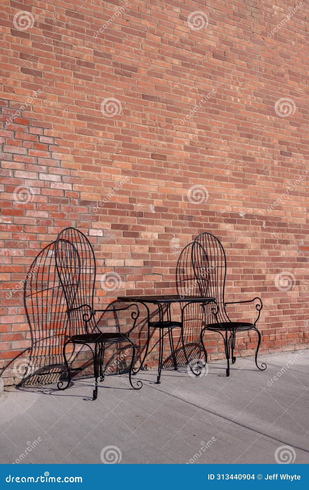 Table and Chairs at an Old Brick Storefront Stock Photo - Image of shop ...