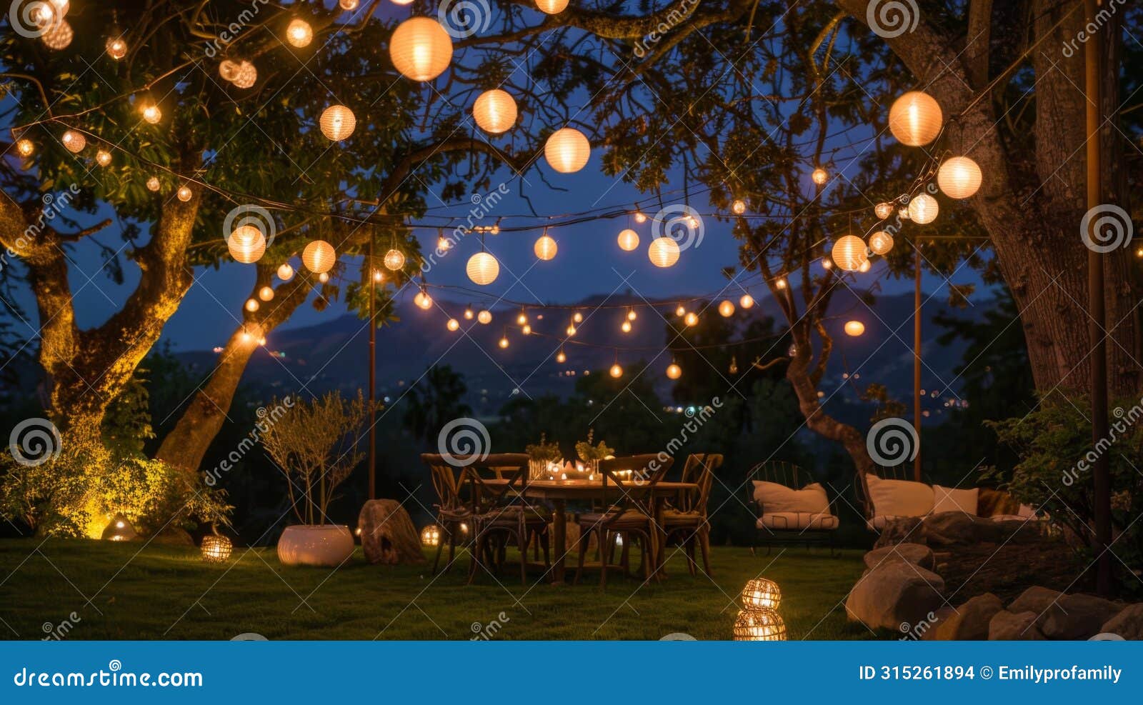 Table and Chairs Under Tree with Hanging Lanterns Stock Photo - Image ...
