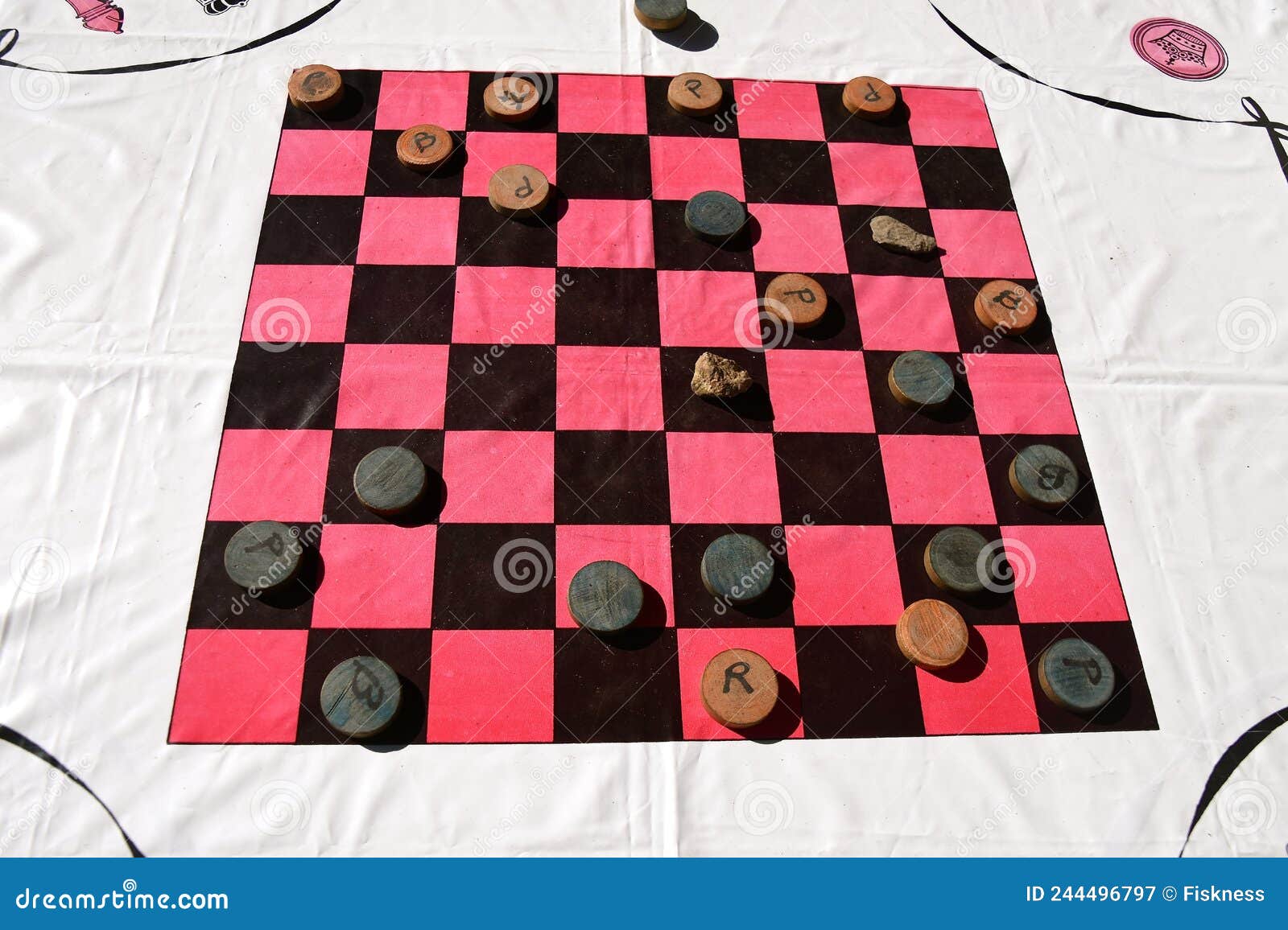 Table Cloth with a Checkerboard Pattern and Wood Checkers Stock Image ...