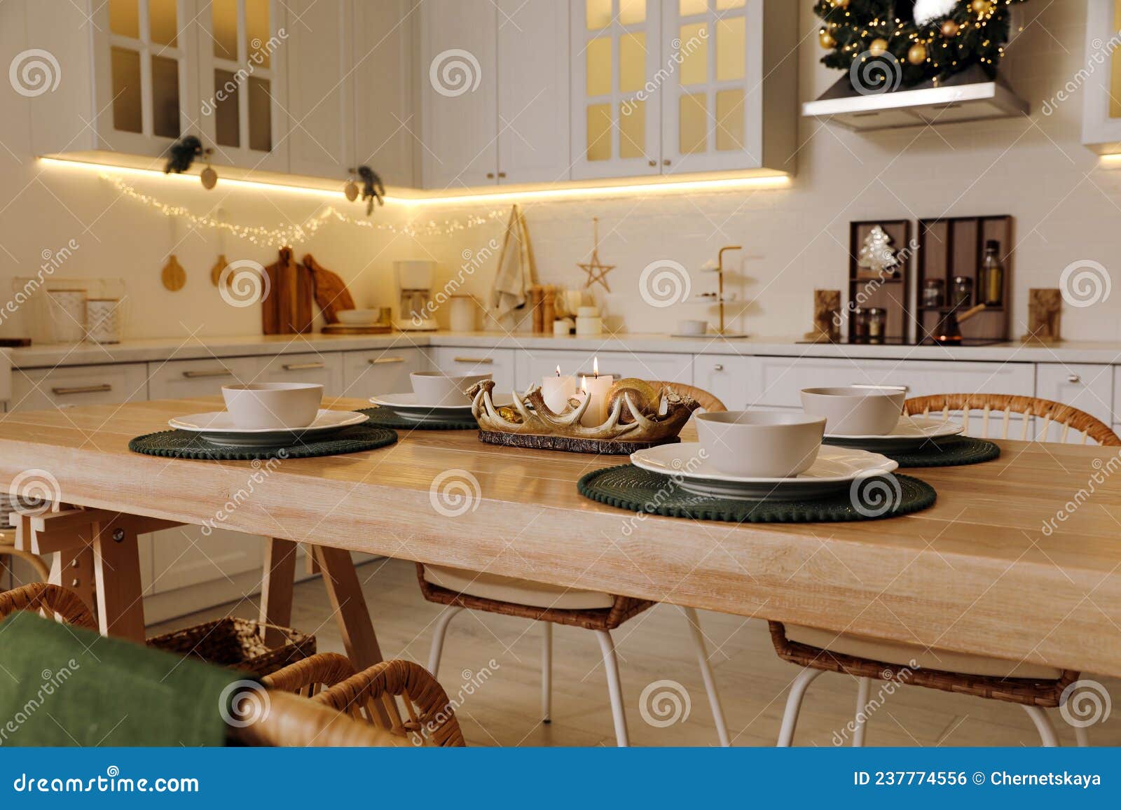 Table with Dishware in Beautiful Kitchen Decorated for Christmas ...