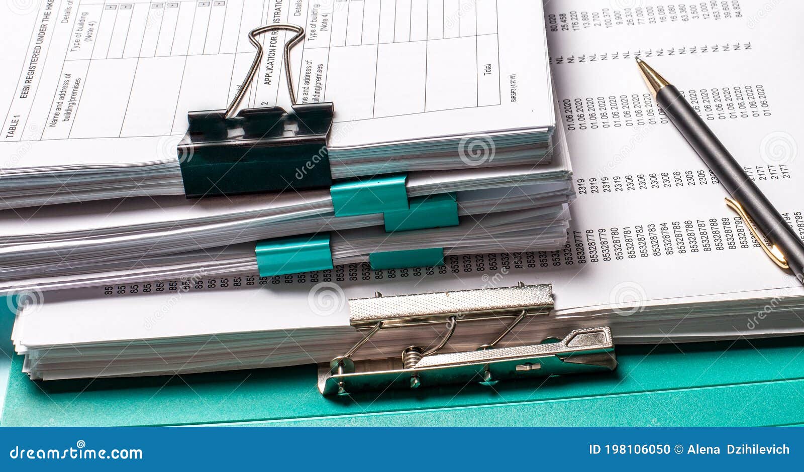 On the Table are Documents Fastened with Clips, a Pen and a Folder with ...