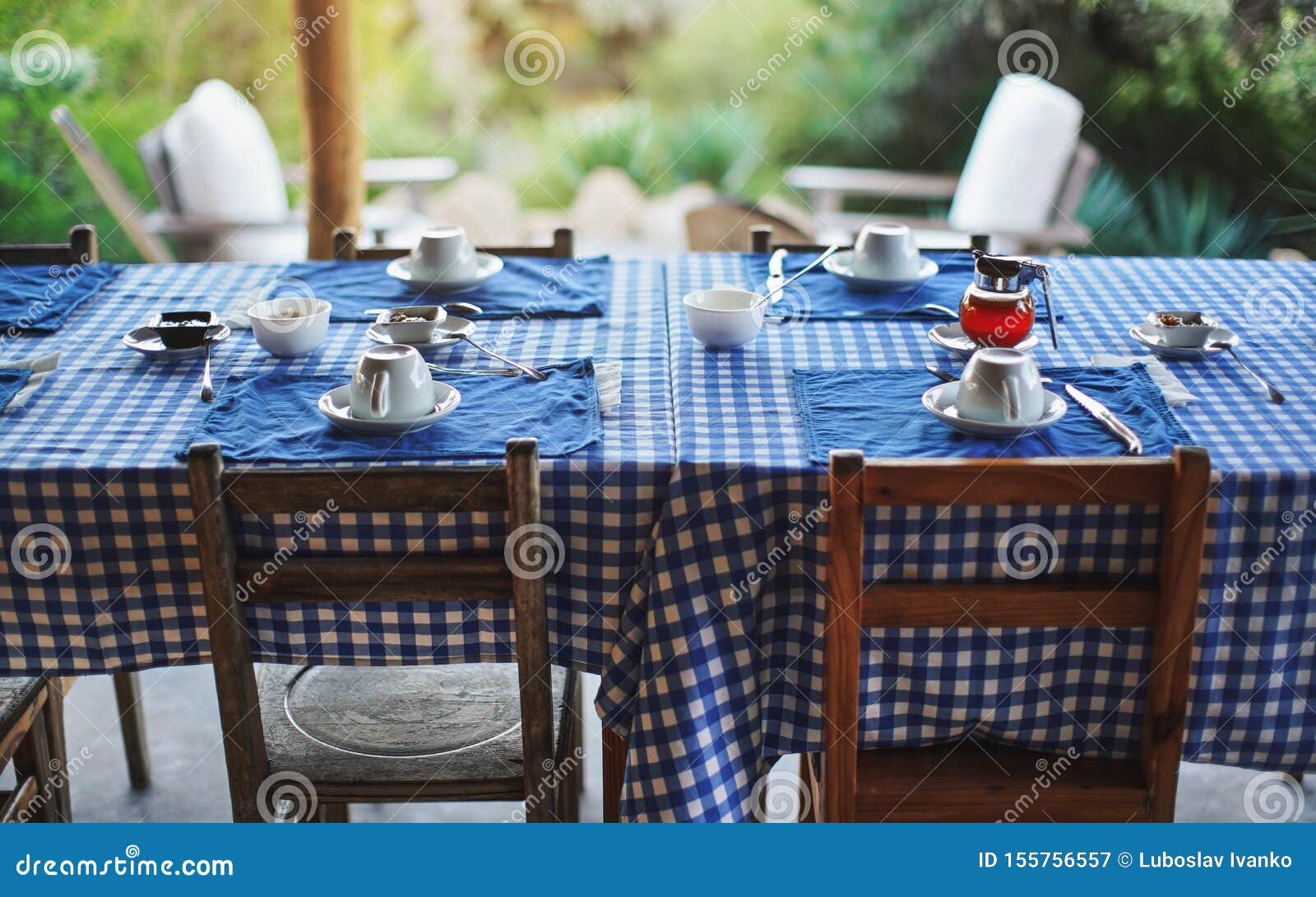Table with Empty Plates and Coffee Cups, Blue Chequered Tablecloth ...
