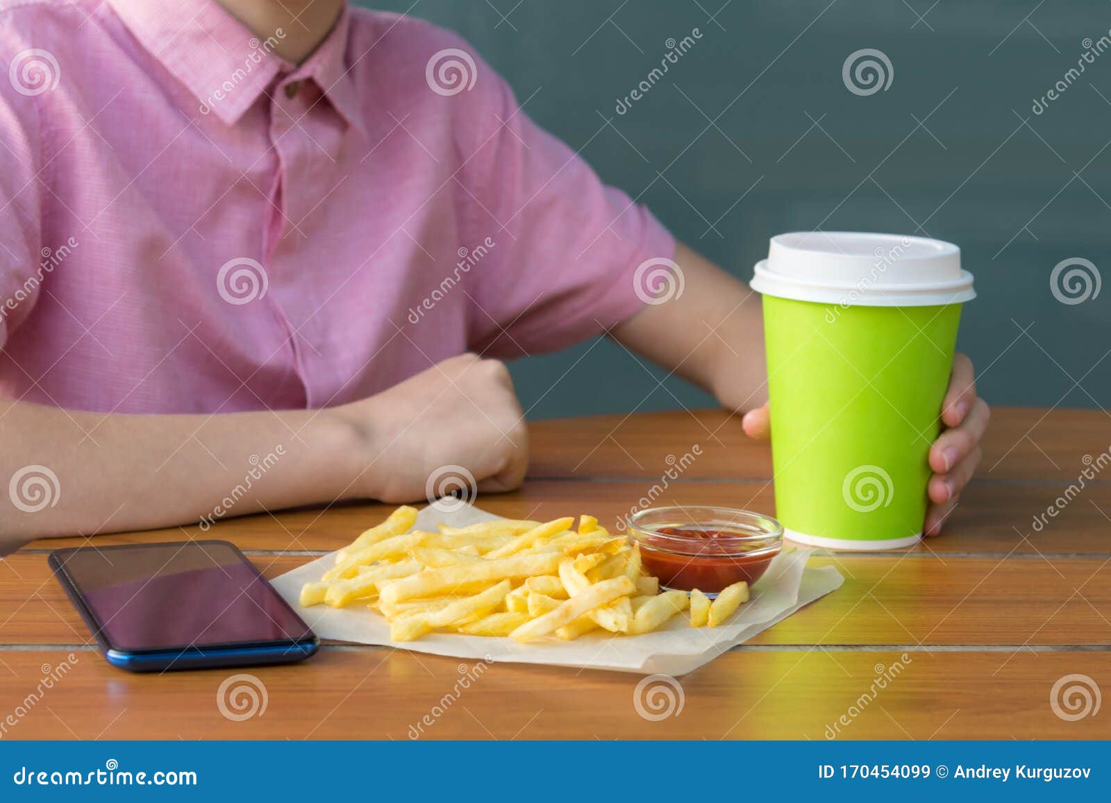 On the Table Fast Food and a Mobile Phone in Front of a School Student ...
