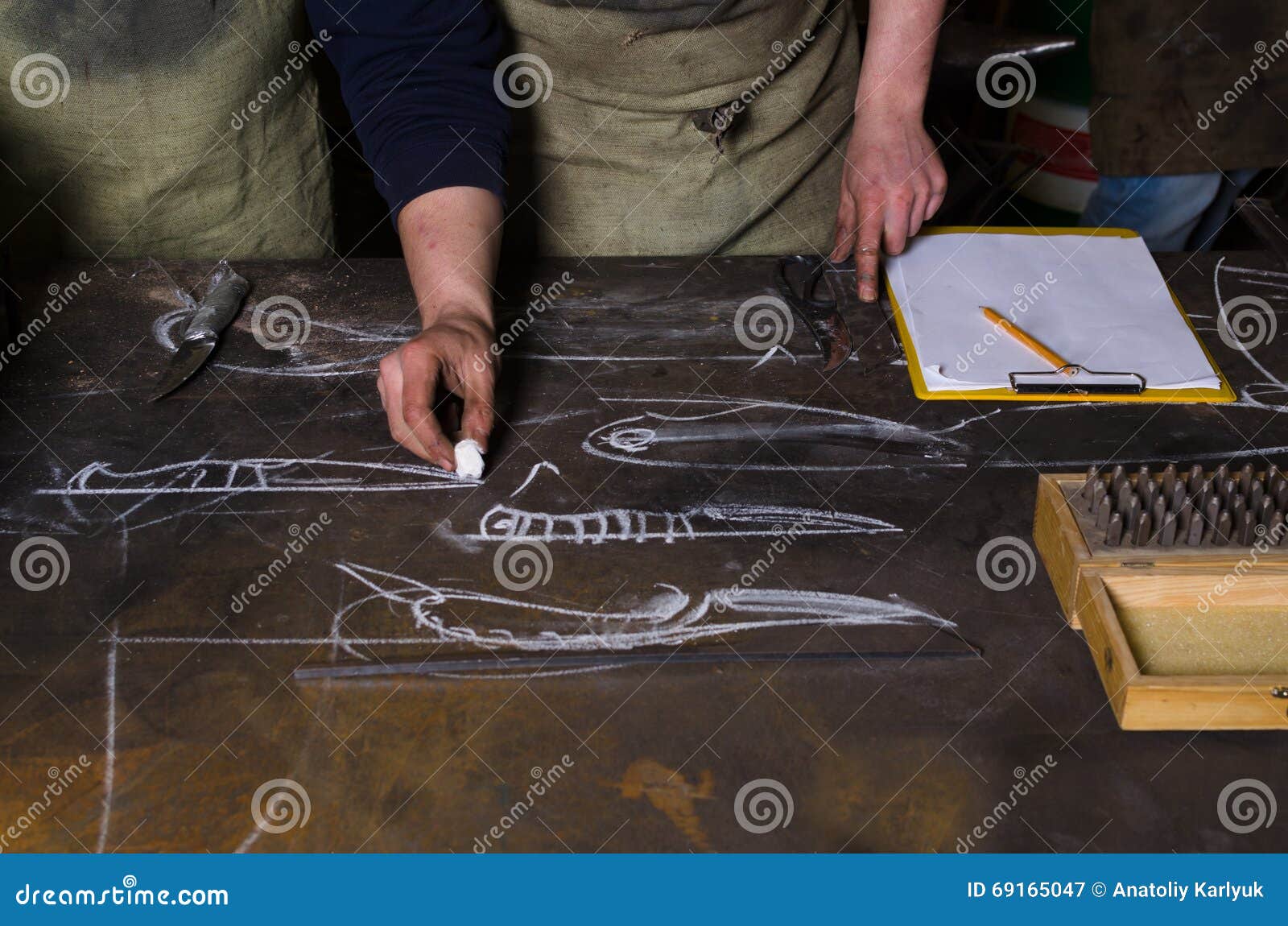 Table in a Forge. Planning Design of Knife. Craftsman Stands Near the ...