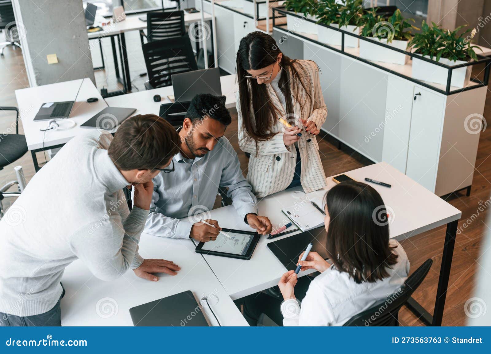 By the Table. Four People are Working in the Office Together Stock ...