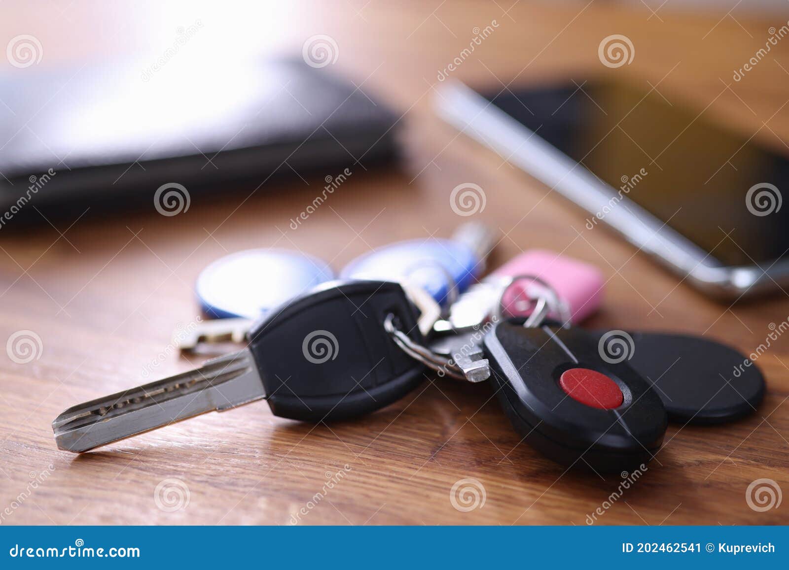 On Table are Keys with Black Remote Control and Red Button Stock Image ...