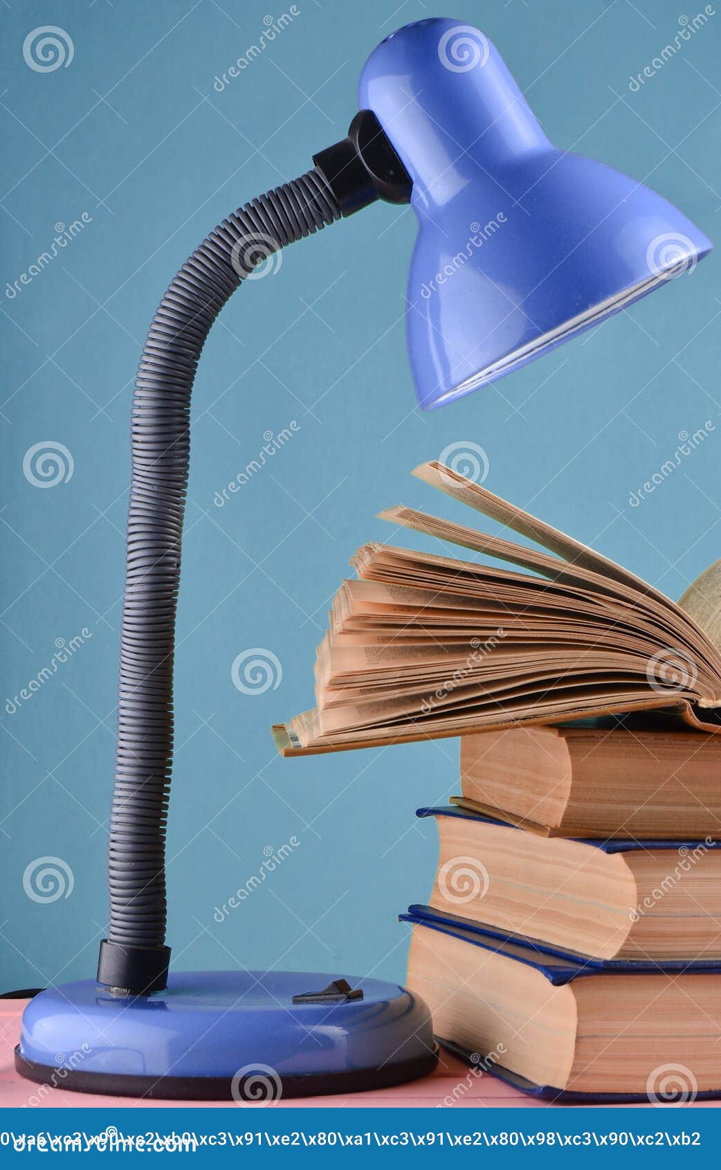 A Table Lamp and a Stack of Books on a Table Isolated Against a Stock ... A Table Lamp and a Stack of Books on a Table Isolated Against a Stock ...