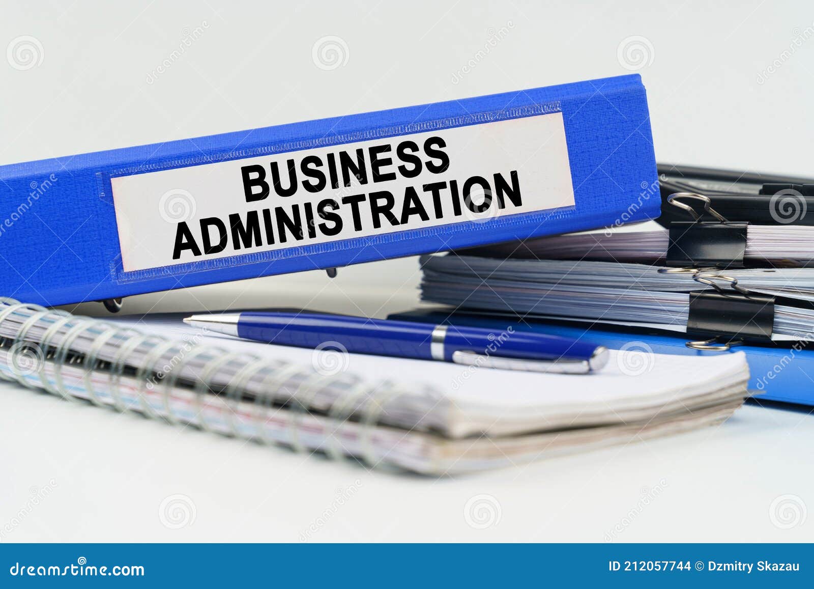 On the Table are a Notebook, a Pen, Documents and a Folder with the ...