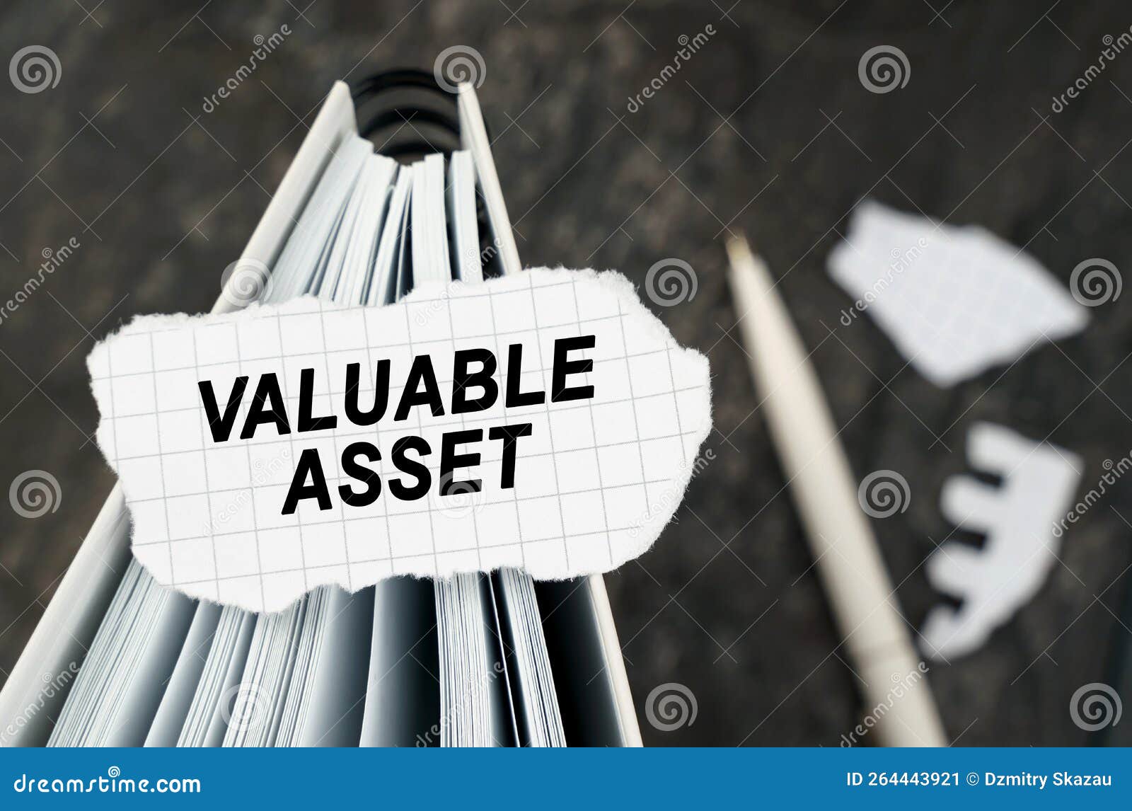 On the Table is a Notebook on Which Lies a Piece of Torn Paper with the ...