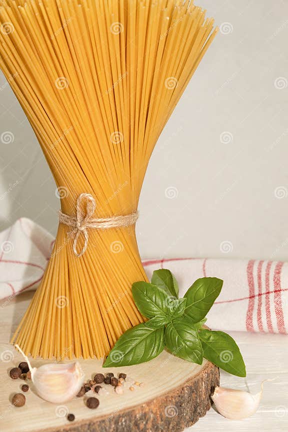 On the Table is a Pack of Spaghetti Tied with String Stock Photo ...