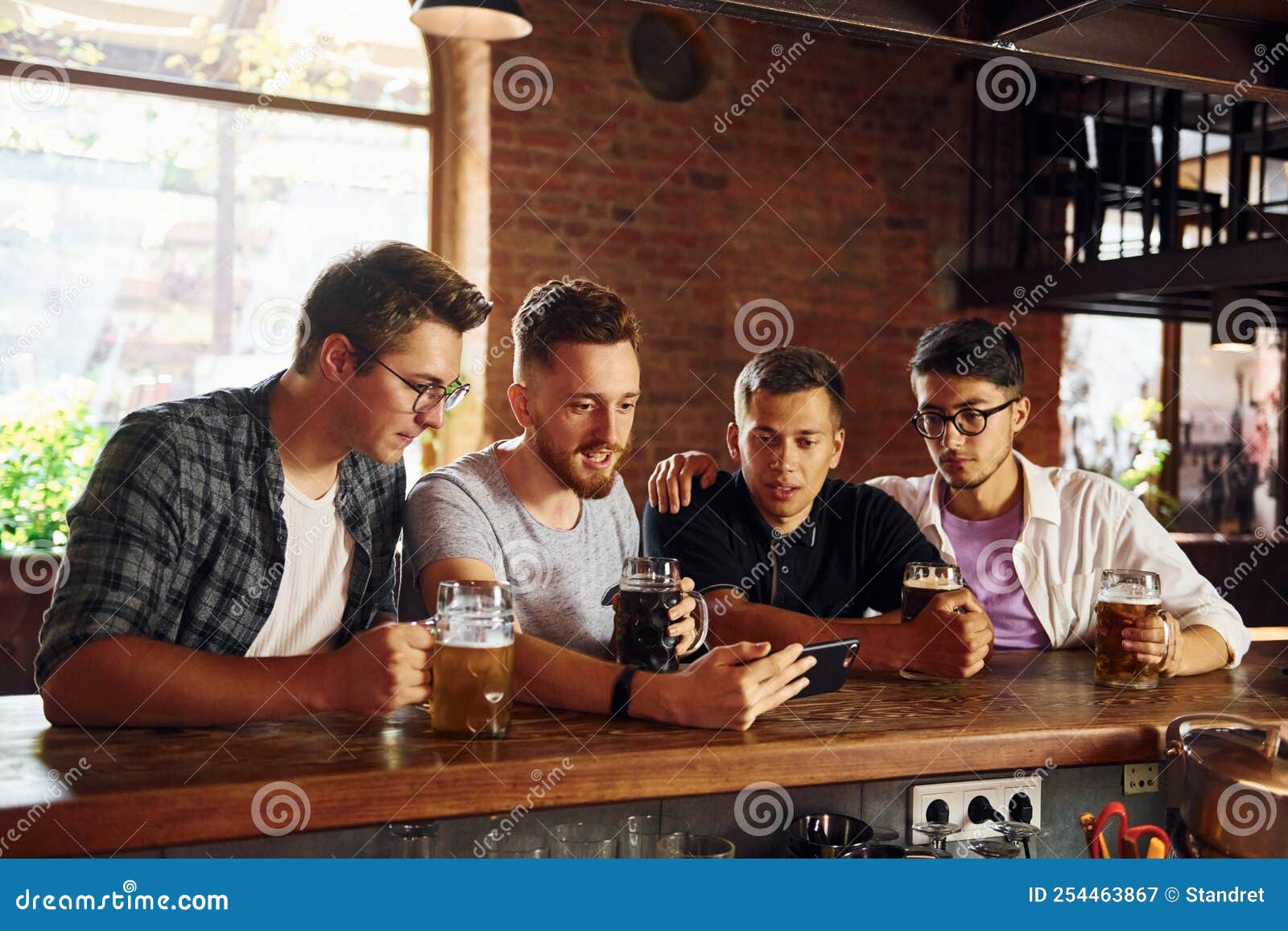 By the Table. People in Casual Clothes Sitting in the Pub Stock Image ...