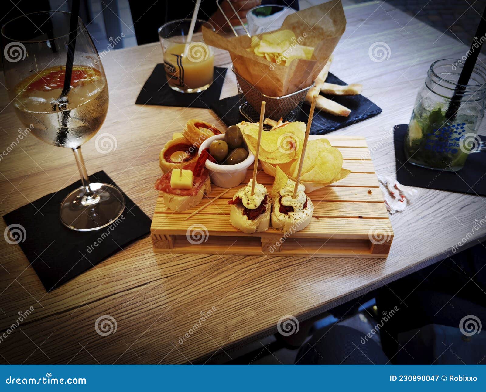Table with Platters of Aperitifs with Snacks and Drinks To Drink in a ...